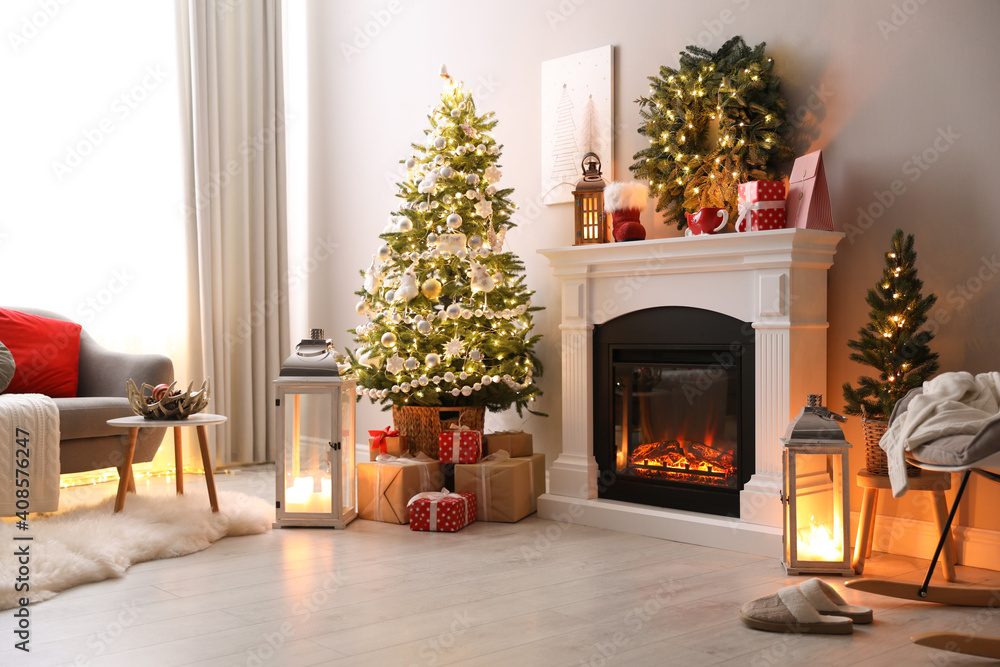 Stylish living room interior with beautiful fireplace, Christmas tree ...