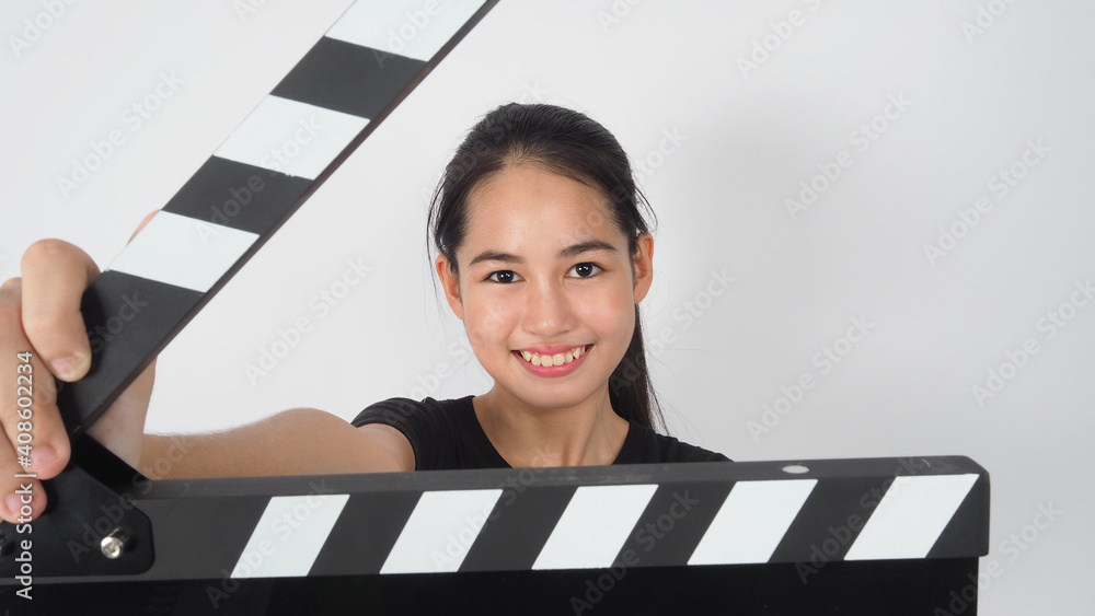 Asian young woman holding black clapper board or movie slate or ...