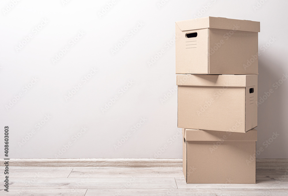 Empty room with cardboard boxes on the floor. Stock Photo | Adobe Stock