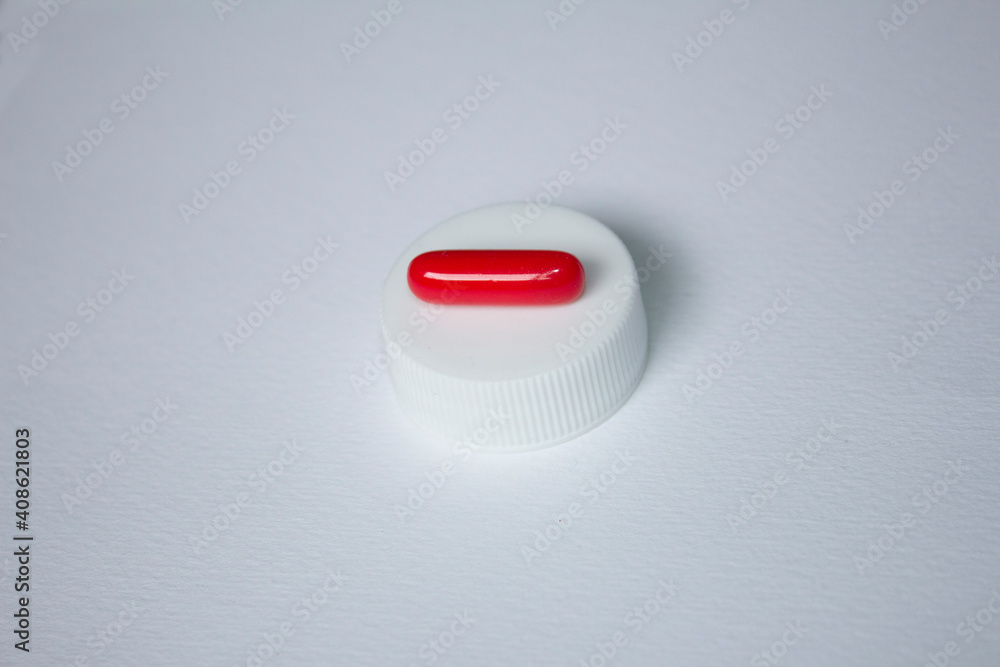PASTILLA ROJA SOBRE BASE Y FONDO BLANCO Stock Photo | Adobe Stock
