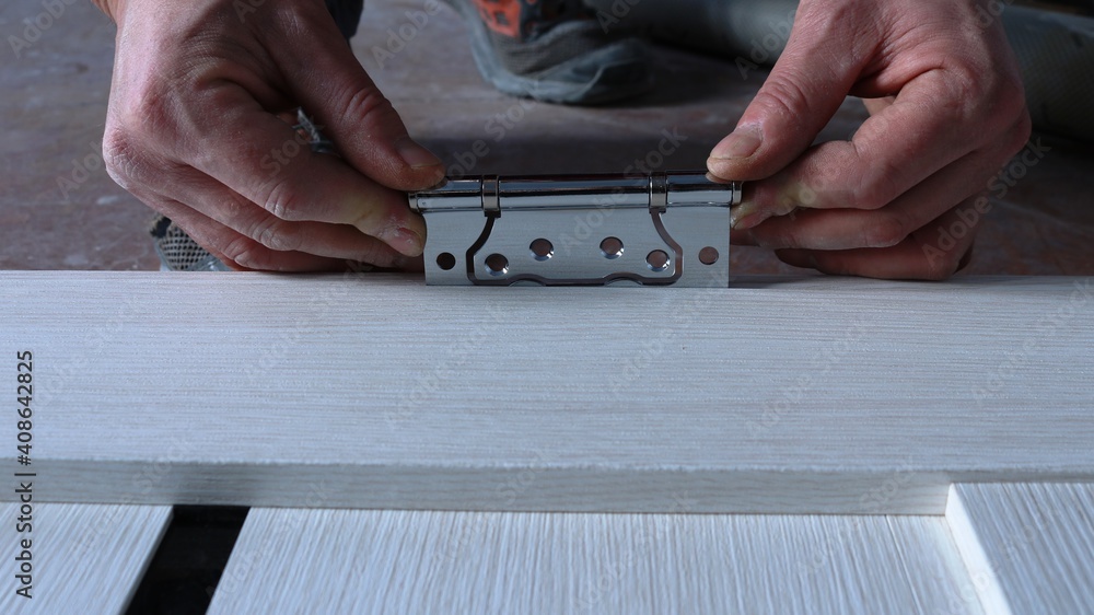 installation of door fittings made of shiny metal close-up, fixation of ...