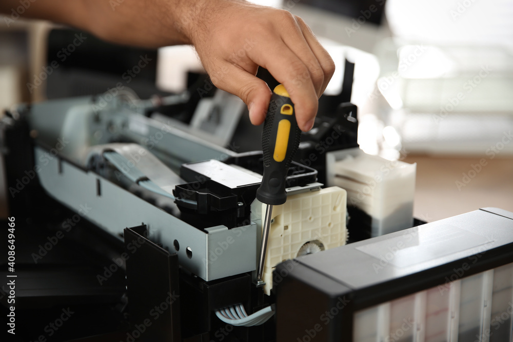 Repairman with screwdriver fixing modern printer, closeup Stock Photo ...