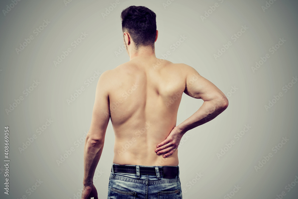 Back view of a fit man with a lower back pain Stock Photo | Adobe Stock