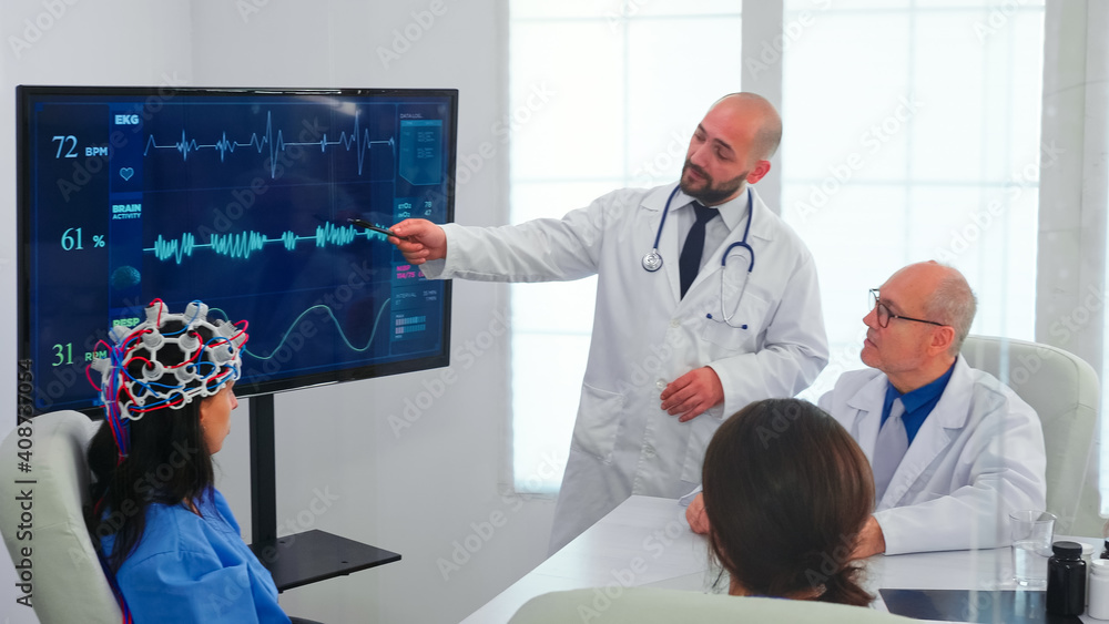Nurse wearing headset with sensors during neuoroscience experiment in ...