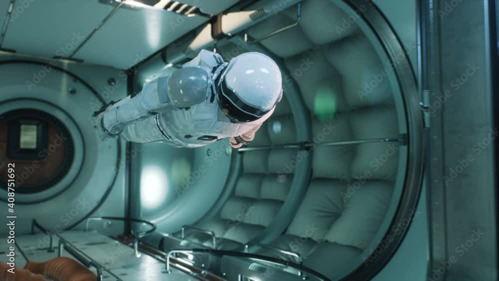 An astronaut in zero gravity checks the module of his spaceship. The ...