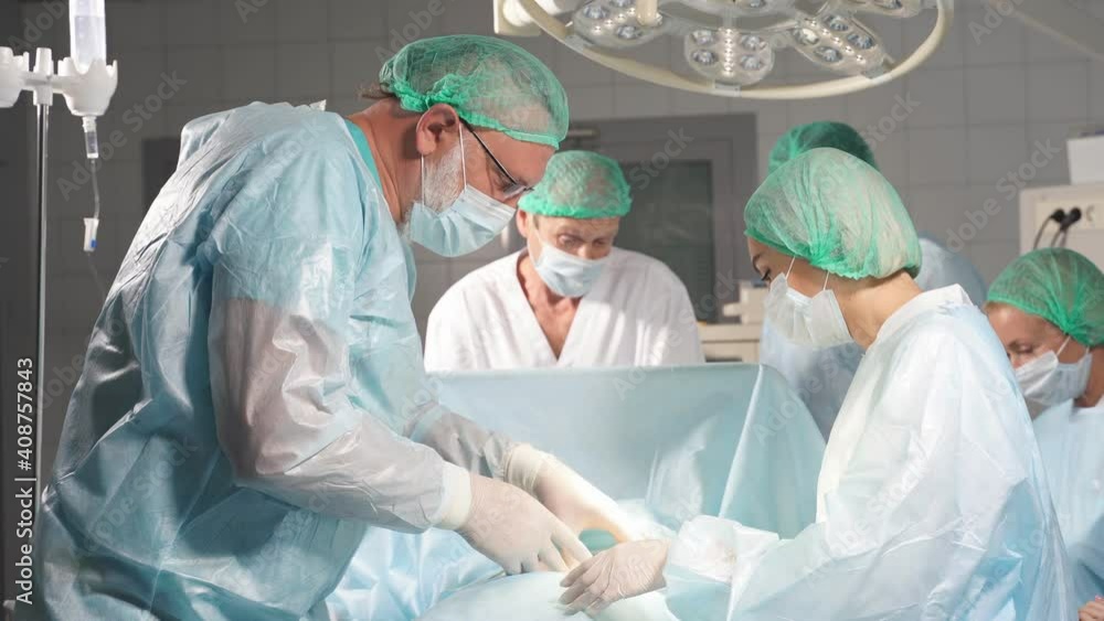 Professional adult doctor shows an example of an operation to interns ...