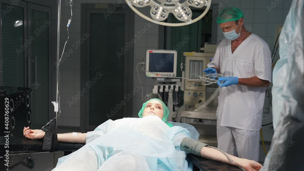 Anesthesiologist using surgical equipment and instruments to prepare ...