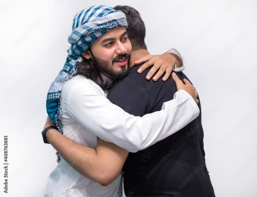 Foto de Muslims hug with each other after Eid prayer, Muslim Arabic brothers meeting together ...