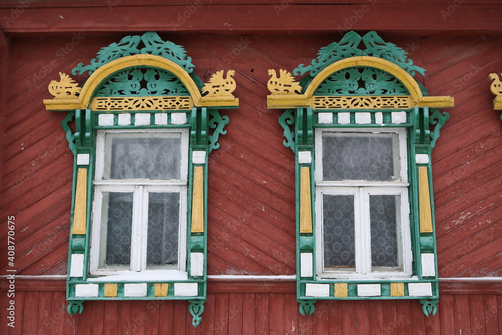Ornamental windows with carved frames on vintage wooden rural house in ...