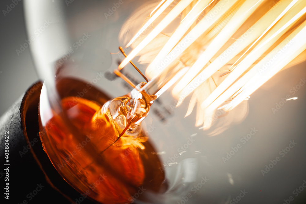 incandescent light bulb with tungsten filaments. Save the energy. Macro ...