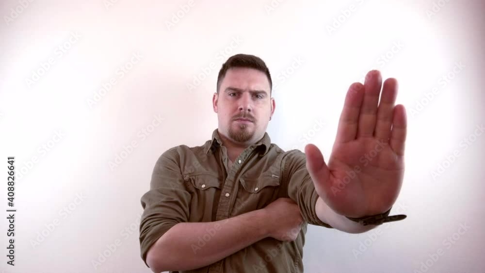 Portrait of a man who holds his arms out in anger and does not let it ...