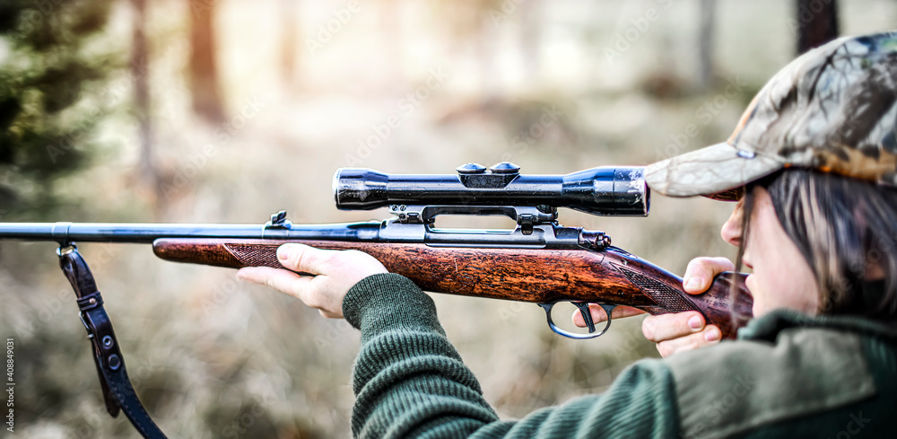 Hunting gun in female hands banner for bussiness. Hunter with rifle is ...