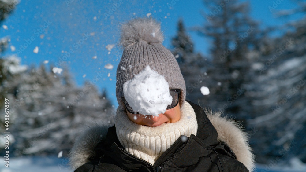 PORTRAIT: Smiling female tourist gets hit in the face by a fluffy ...