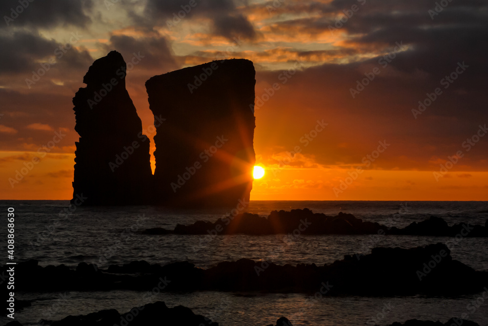 Amazing sunset, silhouette, rocks in the ocean, travel on Sao Miguel ...