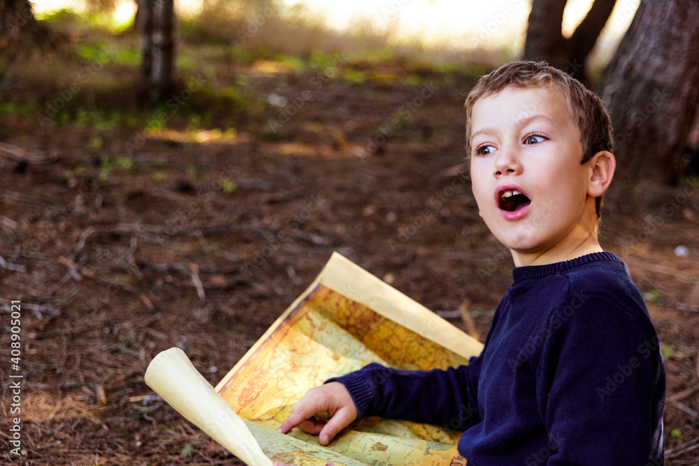 Child with astonished expression to find the location on an old map of ...