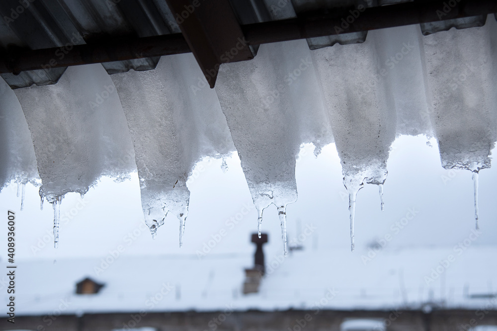 Ice and snow covers roof building, dangerous ice dams hanging from roof ...