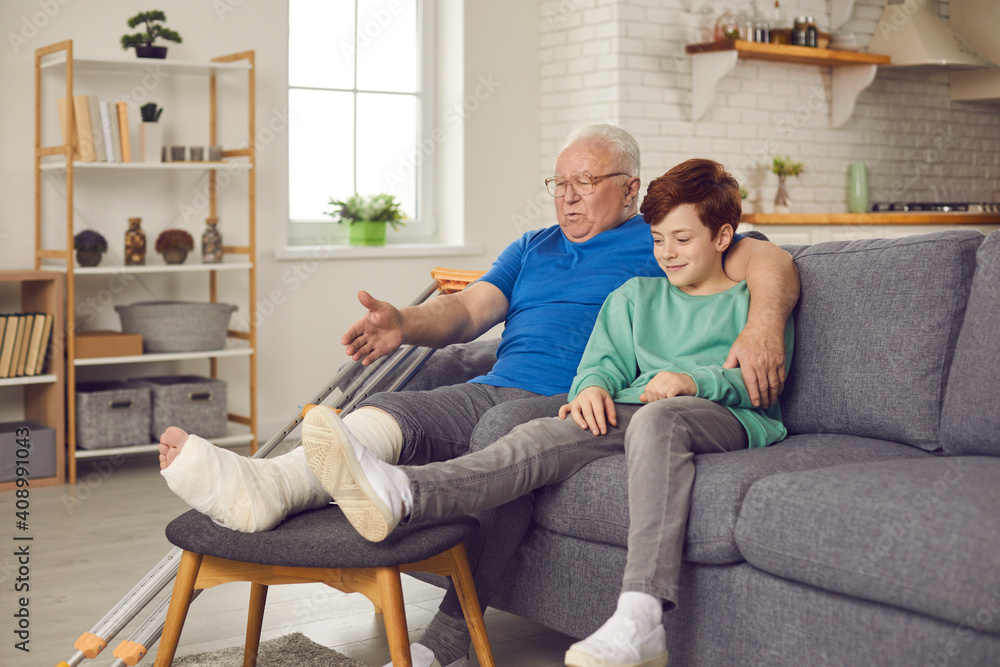 Older man sits on a sofa with a broken leg in a plaster cast and tells ...
