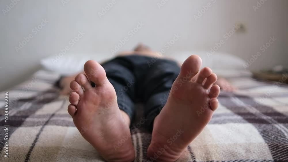 Close-up of the legs. The man is lying on his back. Selective focus. He ...