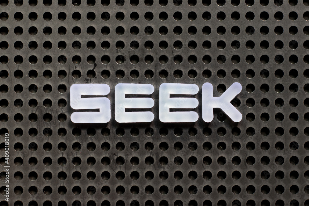 White color letter in word seek on black pegboard background Stock ...