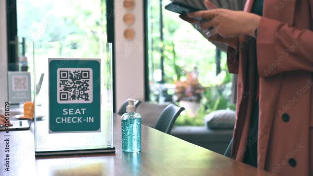 female scan check-in QR code by smartphone app and cleansing hand by ...