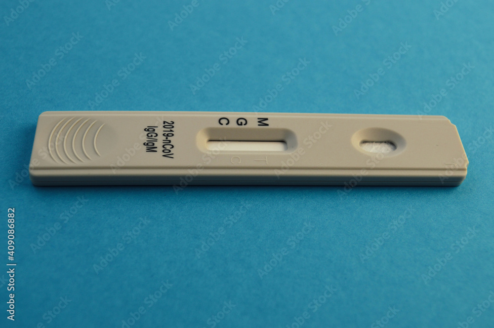individual set for self-diagnosis of coronavirus. test strip on a blue ...