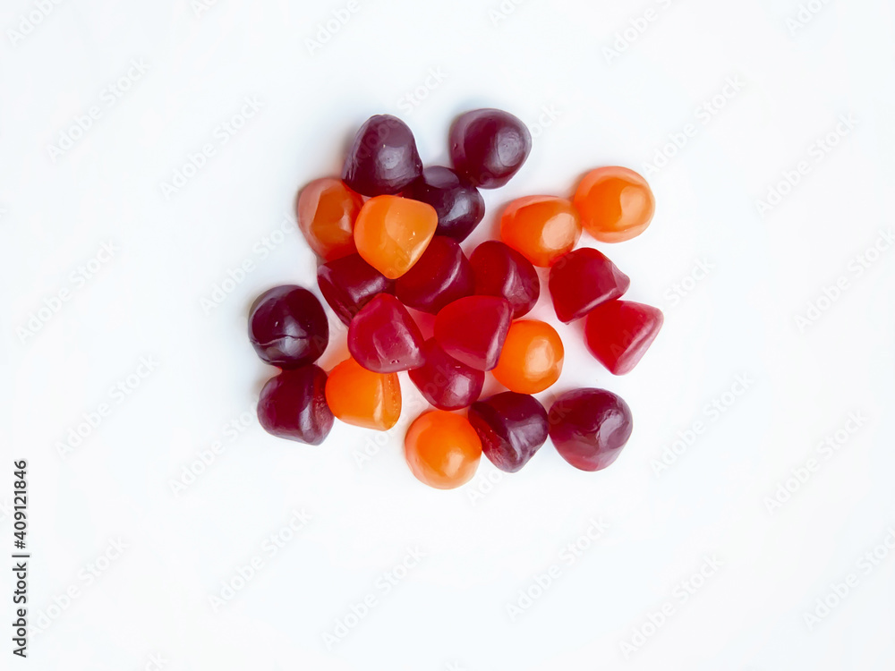 Group of red, orange and purple multivitamin gummies isolated on white ...