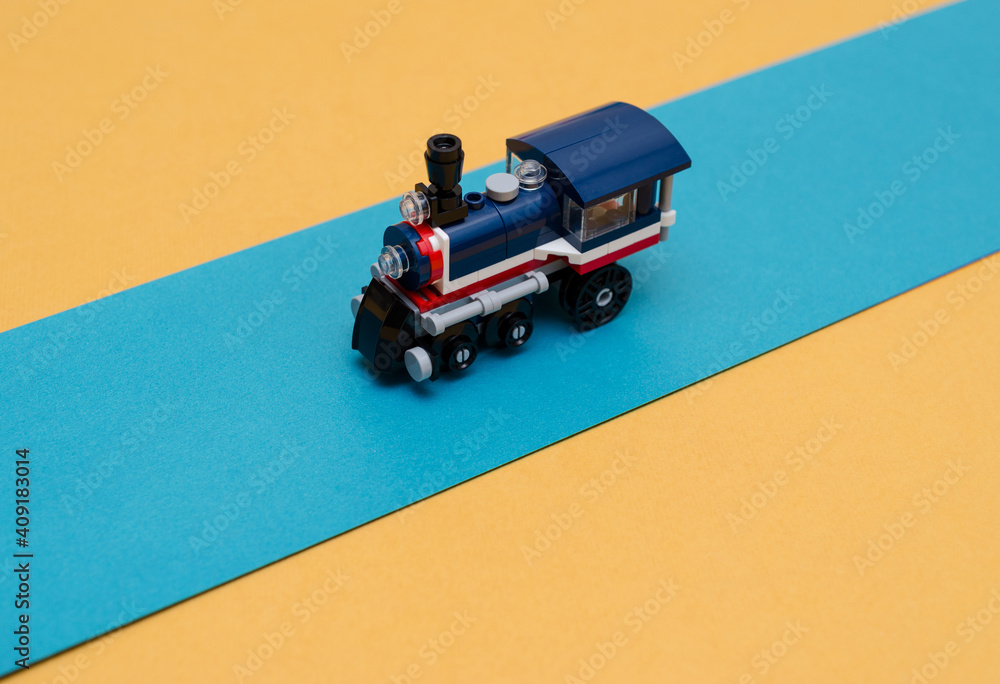 Toy steam train on colored paper. Locomotive for the children's railway ...