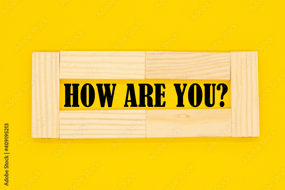 text how are you in a wooden frame on a yellow background. Positive ...