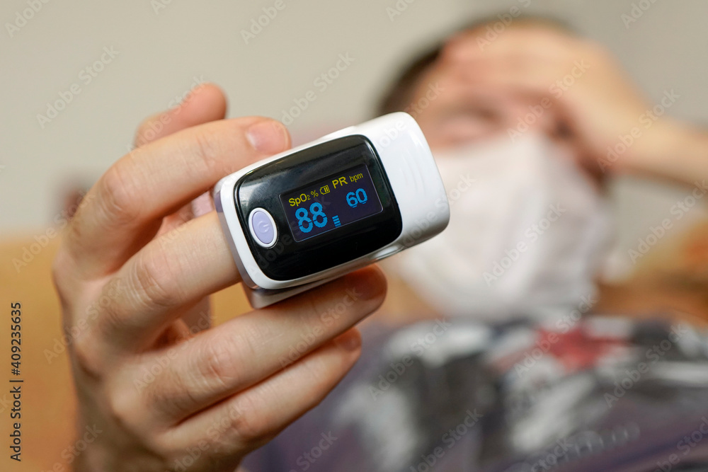 young man is sick with COVID-19 coronavirus and measures oxygen ...