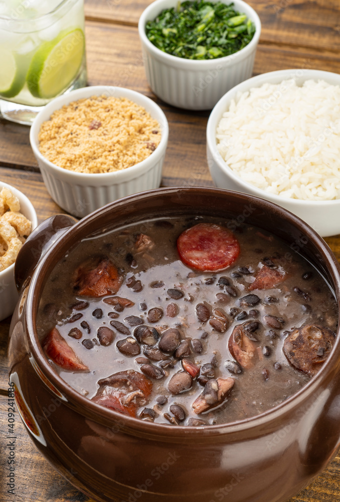 Traditional brazilian feijoada with rice, kale, manioc flour and ...