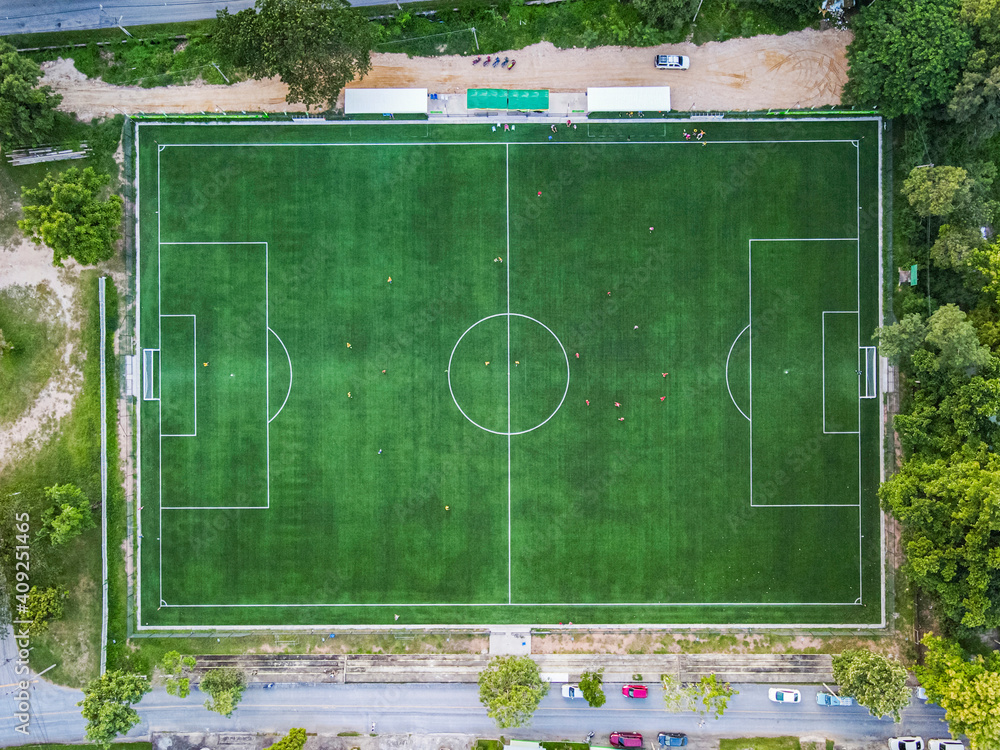 Aerial drone top view of the football soccer field with playing people ...