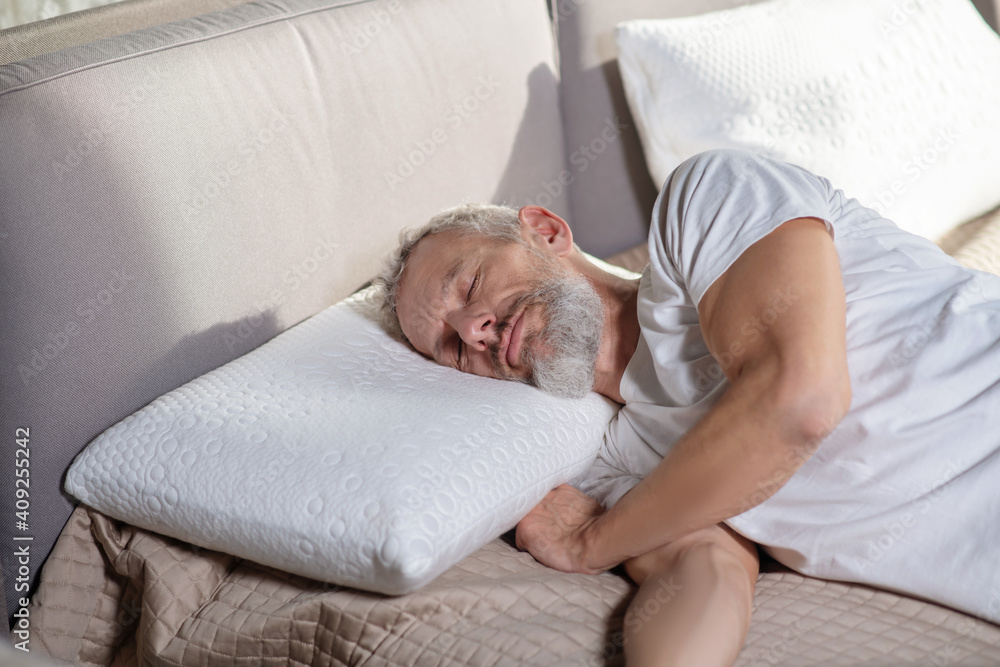 Sleeping adult man lying on the bed Stock Photo | Adobe Stock