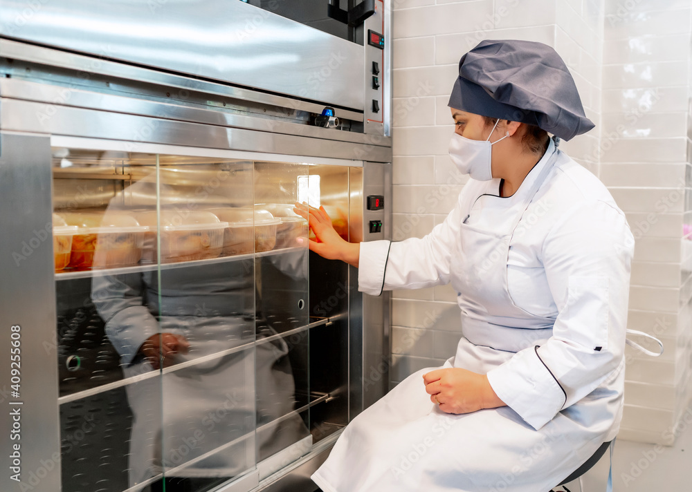 cook in her restaurant placing the food in the cold room Stock Photo ...