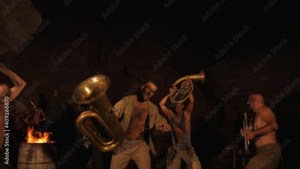 Vidéo Stock Funny musicians play underground in a cave at night. Crazy ...