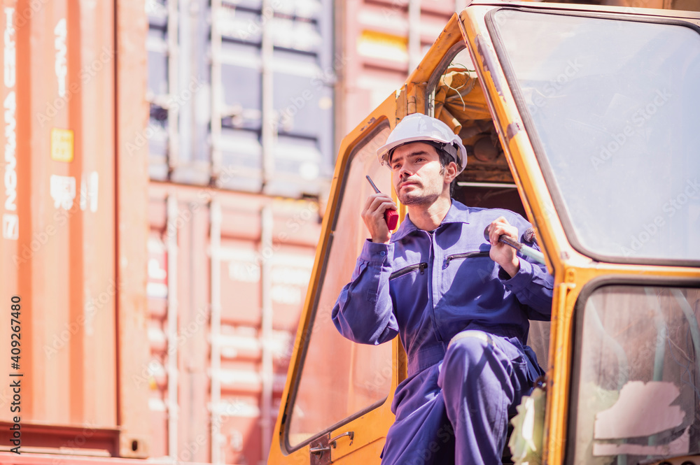 The foreman controls the loading of container boxes from a cargo ship ...