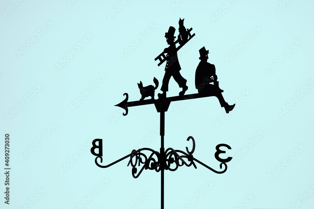 Weather vane with figures of a man and a cat and indicating the ...