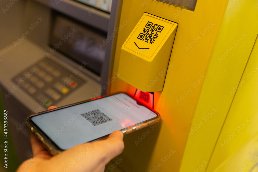 Contactless use of an ATM, reading a QR code from a smartphone, Stock ...