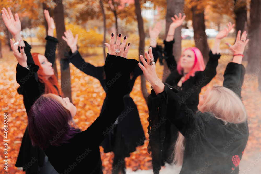 Coven of witches, a group of friends as witches on Halloween perform a ...