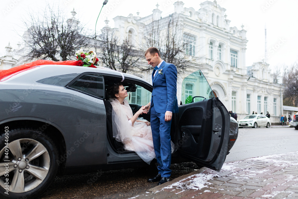 the bride and groom are sitting in a car decorated with flowers, the ...