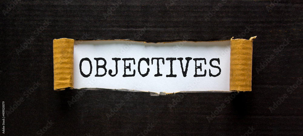 Objectives symbol. The word 'objectives' appearing behind torn black ...