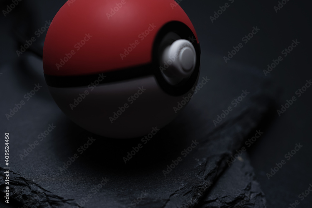 KUALA LUMPUR, MALAYSIA - JUNE 13TH, 2019 : A Poké Ball Plus on a black ...