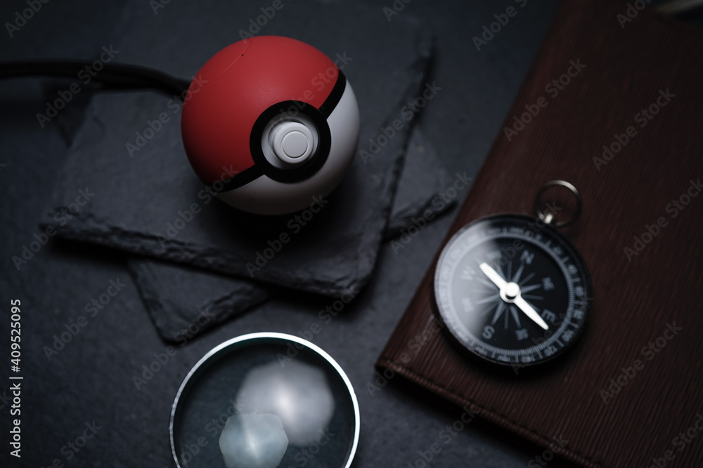 KUALA LUMPUR, MALAYSIA - JUNE 13TH, 2019 : A Poké Ball Plus on a black ...