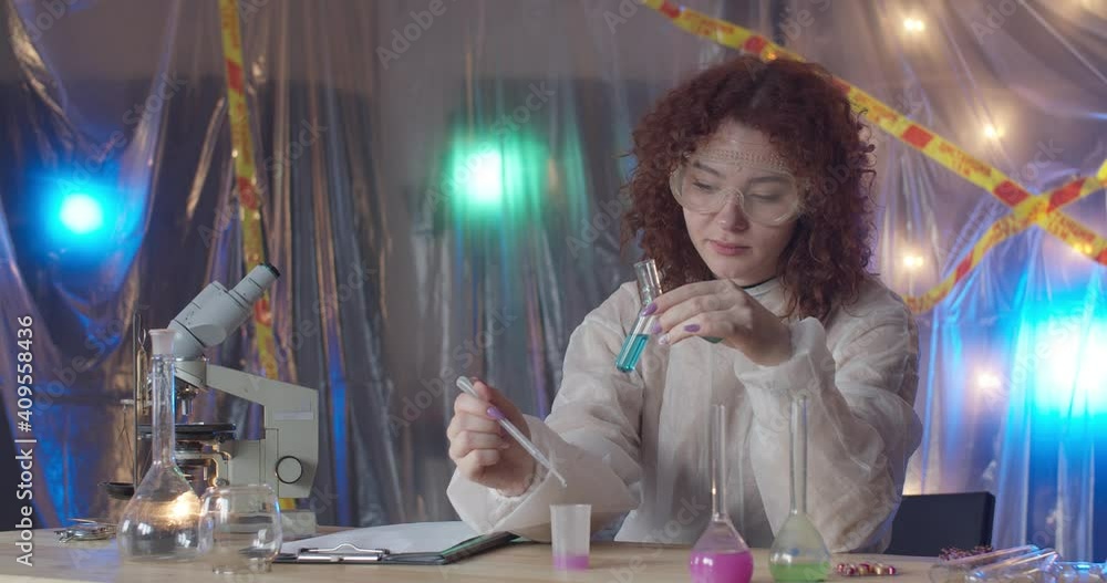 Mobile laboratory. Girl scientist observes the reaction in a test tube ...