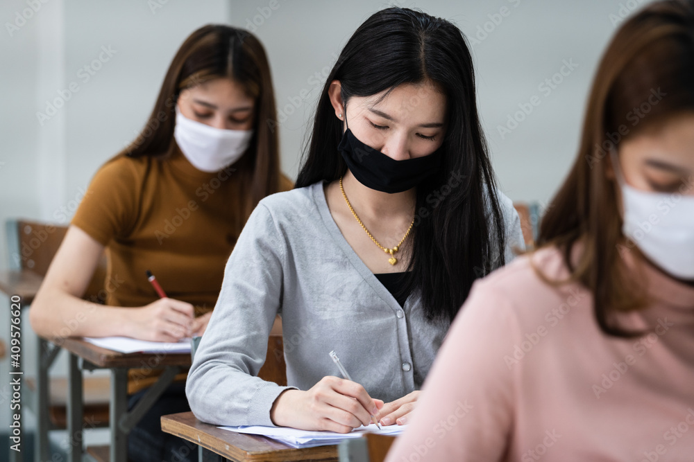 Female teenager college students wears face mask and keep distance ...