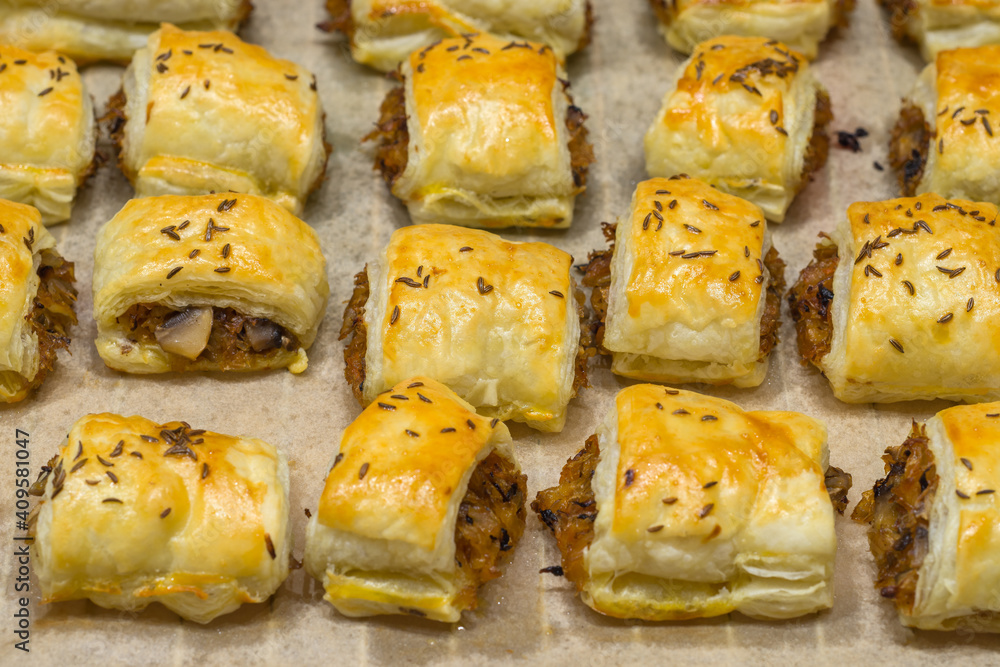 Fresh and flaky puff pastry pasty filled with cabbage and champignon ...