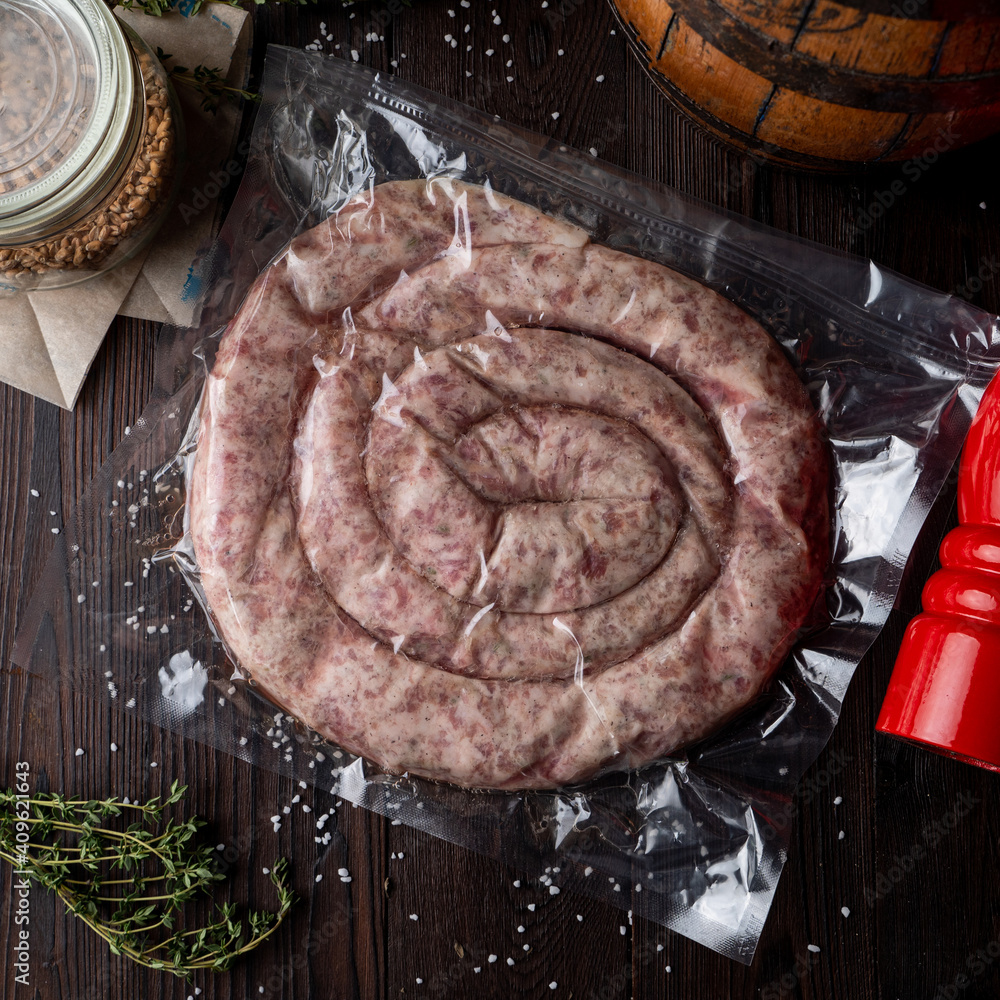 Raw twisted wurst in a vacuum packaging, food delivery during pandemic ...