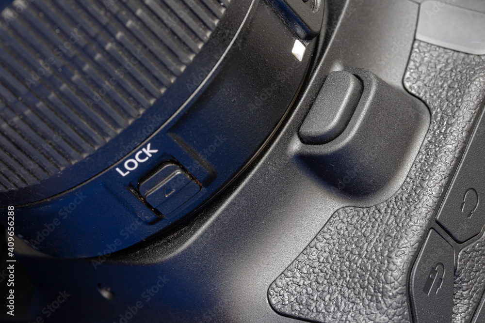 Detailed view of a lens with a zoom and focusing ring and a button lock ...