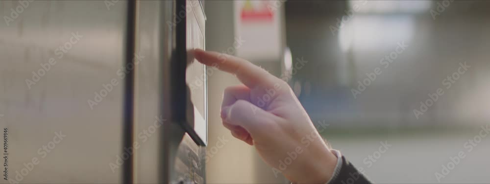 Adjusting setting on process control panel. Close-up of finger tapping ...