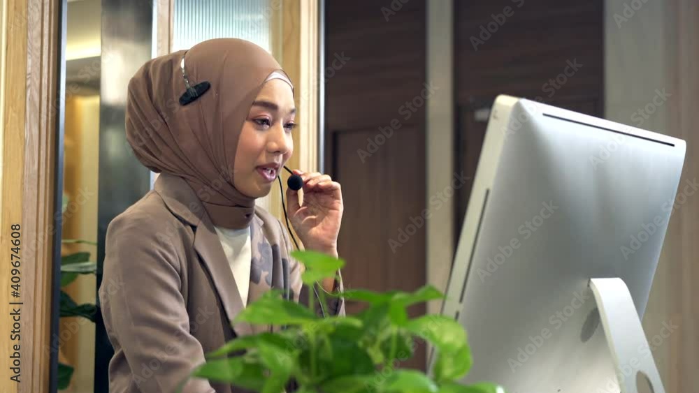 Beautiful Asian Muslim women wearing hijab working in call center ...