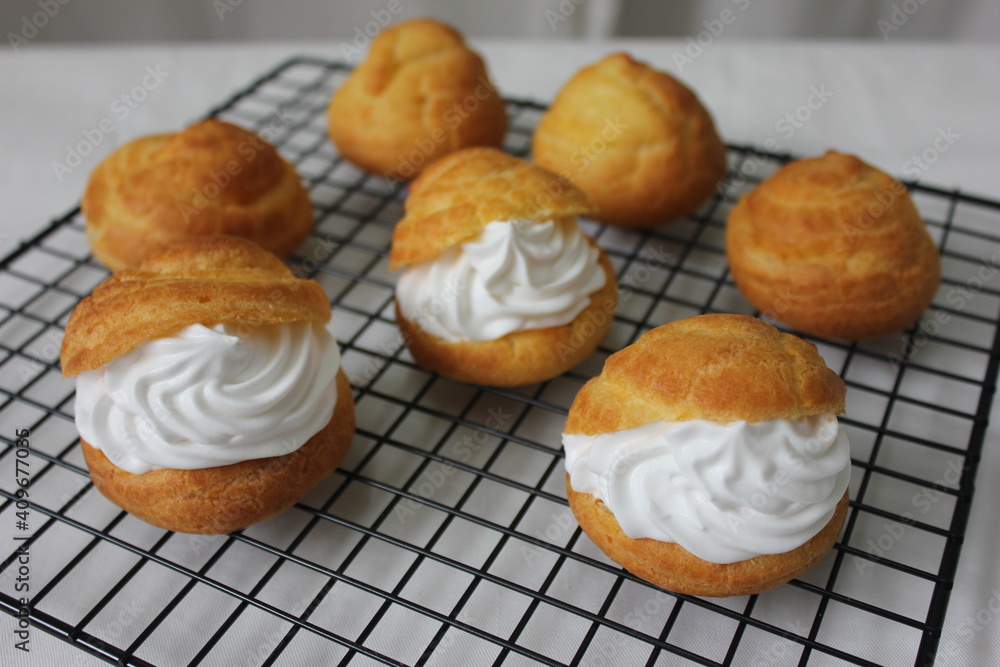 Delicious Homemade small cakes profiterole choux pastry with custard ...